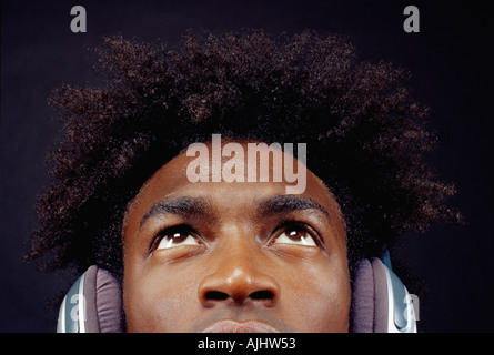 Afro american man wearing headphones listening to music over isolated ...