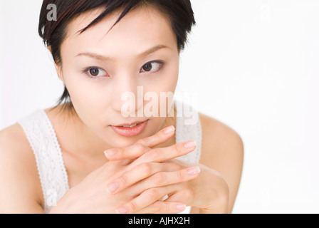Smiling young woman looking away on blue background Stock Photo - Alamy