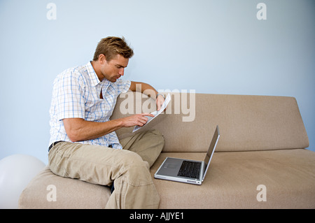 Man settling bill online Stock Photo - Alamy