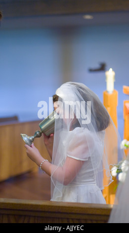 A child receiving the First Holy Communion Stock Photo - Alamy