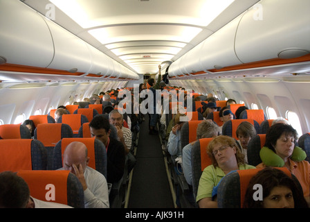 Interior of Easy Jet easyjet plane airplane with passengers seated ...