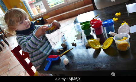 small boy playing with modeling clay Stock Photo - Alamy