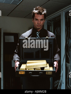 Man with a briefcase of gold bars Stock Photo - Alamy