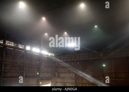 Large Empty Dusty Warehouse With Lights Shining Through Dust Stock ...