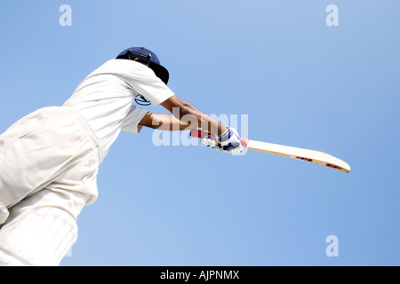low angle shot of a Cricketer batsman hitting a lofted shot during a ...