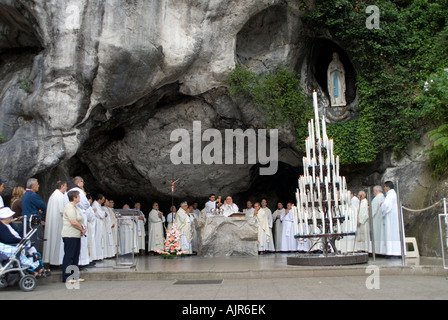 Blessings given by priest in front of Grotto, Statue of Maria and ...
