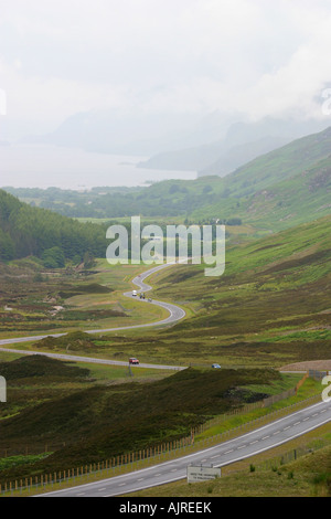 A long bendy Scottish road winding through farmers fields with hazard ...