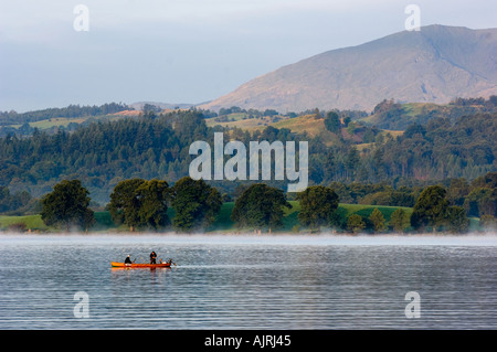Lake District fishing on Lake Windermere with early morning mist with ...