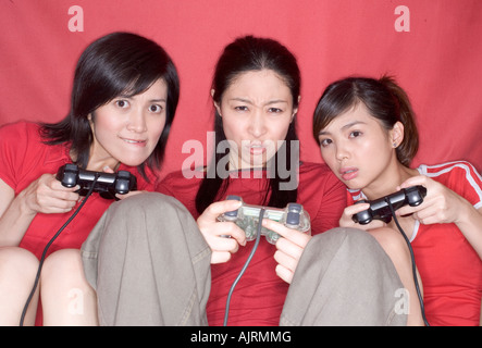 young Asian women playing video game using controller relaxing on ...