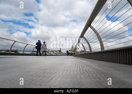 A low wide angle view of the Millenium Bridge with The Tate Modern in ...