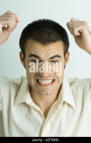 Angry man throwing a temper tantrum clenching his fists and yelling ...