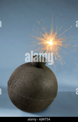 An old fashioned style round bomb with a lit fuse about to explode ...
