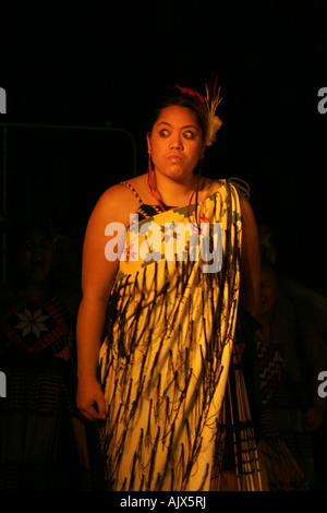 A New Zealand Maori woman in a kapa haka (traditional dance) costume ...