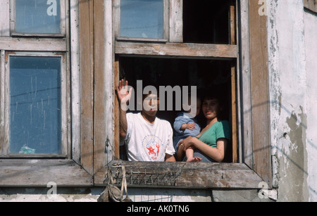Family at the window of a house, Lorino village, Chukotka province ...
