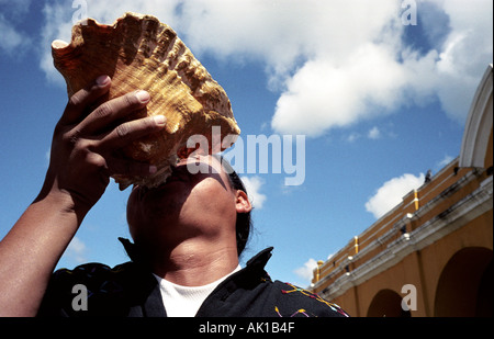 Musician Blowing Shell Stock Photo - Alamy