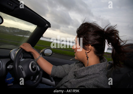 Driving a Mini Cooper convertible car along country lane on touring ...