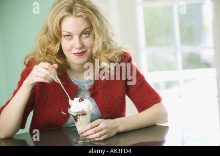 Woman eating a chocolate sundae Stock Photo - Alamy