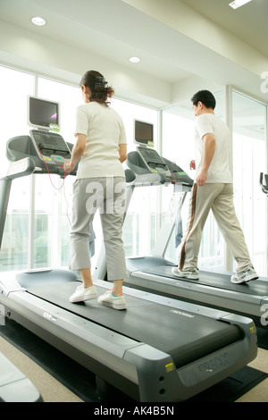 Rear view of woman on treadmill in gym Stock Photo - Alamy