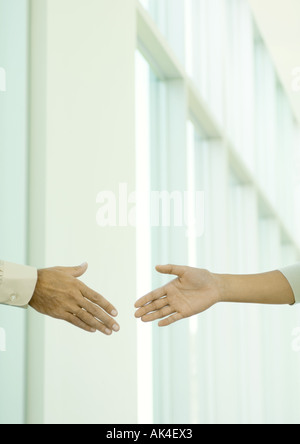 Handshake reach of businessman Stock Photo - Alamy
