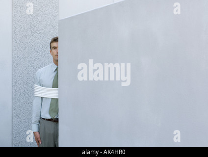 Business man tied up with ropes outdoors Stock Photo - Alamy