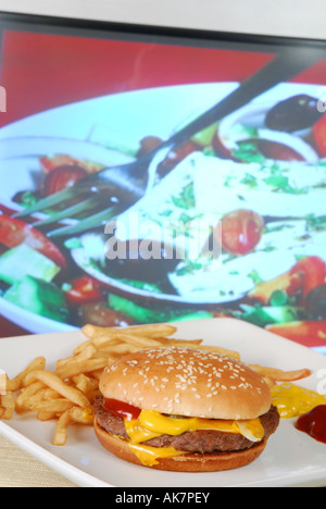 Concept shot to show unhealthy fast food TV dinner in front of ...