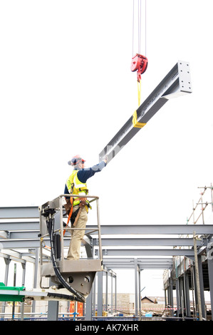 A construction worker on a platform guiding liquid concrete into ...