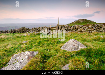 Just before dawn at Buckland Beacon on Dartmoor with a dry stone wall ...