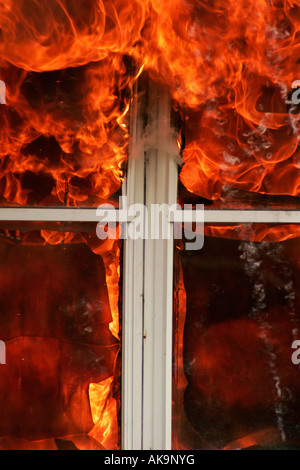 Flames escaping out of the window of a house Stock Photo - Alamy