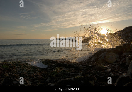Sunset on the sea with the waves Stock Photo - Alamy