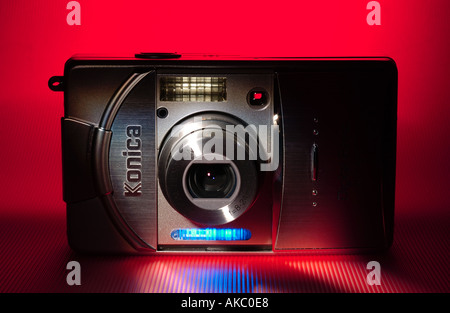 Digital camera on light background Stock Photo - Alamy