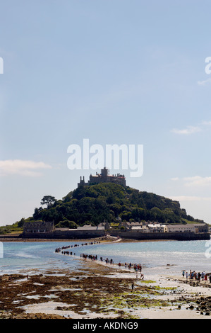 Visitors wade across the causeway, submerged in seawater to and from ...