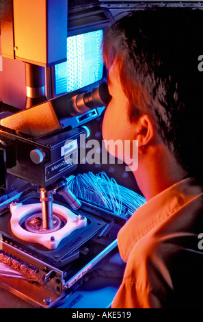 Precise technician in high tech facility repairing network issues ...