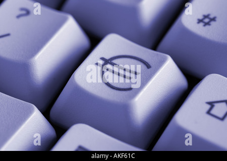 Euro Symbol on a laptop computer keyboard focus on it with a financial ...