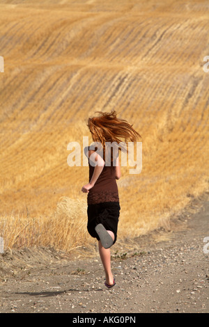 Young girl running down a Saskatchewan country road Stock Photo - Alamy