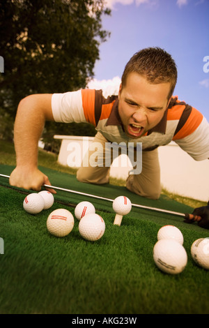 Frustrated golfer yelling at golf balls Stock Photo - Alamy