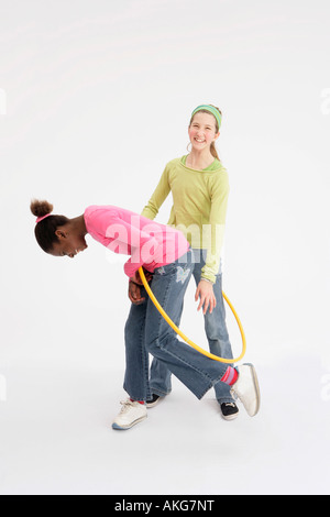 Two girls playing hulahoop Stock Photo - Alamy