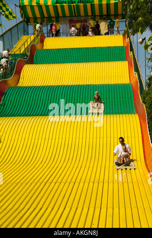 Children ride down a giant yellow slide at the Iowa state fair in Des ...