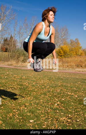 Young woman getting ready to jump Stock Photo - Alamy