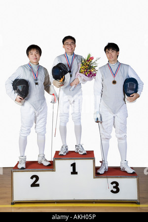 Winning, fencing and men with medal in portrait for celebration after ...
