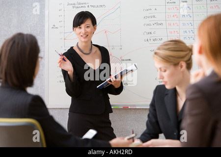 Asian woman giving a note to a young Caucasian man Stock Photo - Alamy