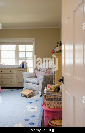 Baby toy on chair, door background Stock Photo - Alamy