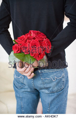 Man holding flower behind his back, rear view Stock Photo: 19889749 - Alamy