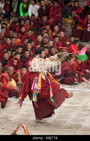 Monks dance with ribbons representing deity powers at the Monlam Chenmo ...