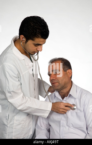 Doctor checking heart beat of patient in bed with stethoscope Stock ...