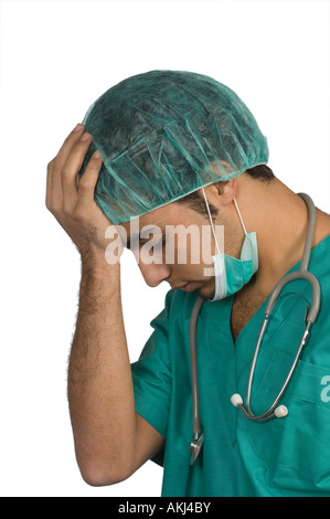 Tired doctor with surgical cap and stethoscope Stock Photo - Alamy