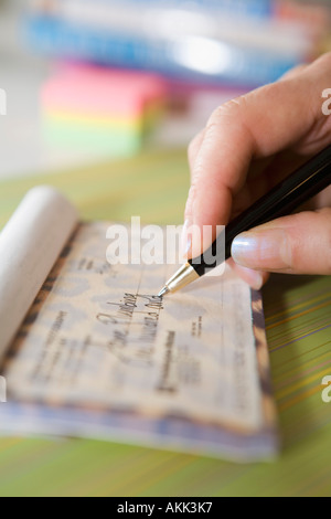 Hand writing check Stock Photo - Alamy