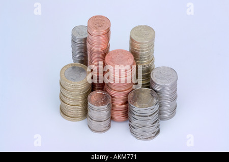 small stacks of sterling 2p and 1p coins standing on a jumble of 2p and ...