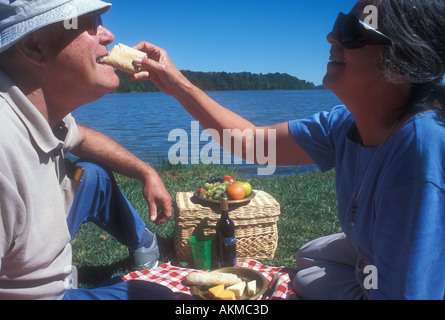 A Couple outdoors by lake having good time Stock Photo - Alamy