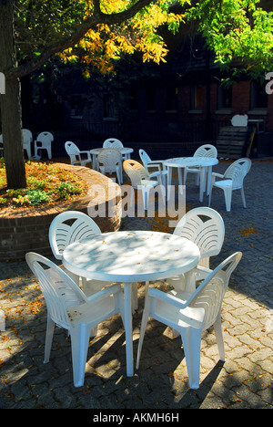 Outdoor cafe with white plastic tables and a chairs Stock Photo - Alamy