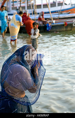 Woman praying. Shivala Ghat. Ganges river. Varanasi. India Stock Photo ...